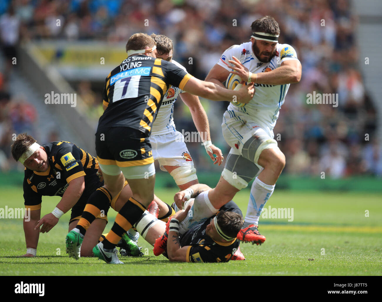 Wasps' Guy Thompson (floor) tackles Exeter Chiefs' Don Armand during ...