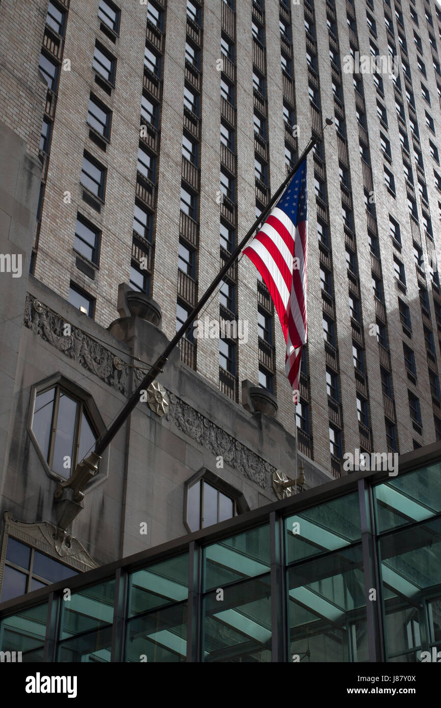 US flag with building in the background photographed in a city or metro ...