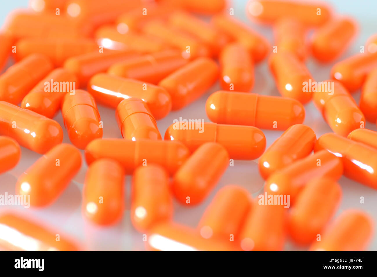Orange drug capsules spilling hi-res stock photography and images - Alamy