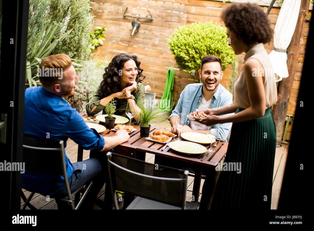 Young people have lunch in the backyard Stock Photo - Alamy