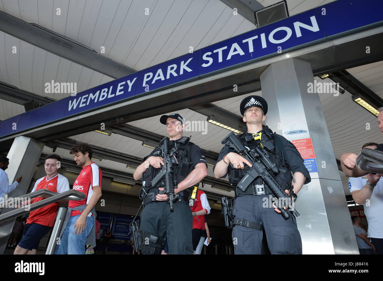 Armed police officers patrol outside Wembley Park Station near Wembley ...