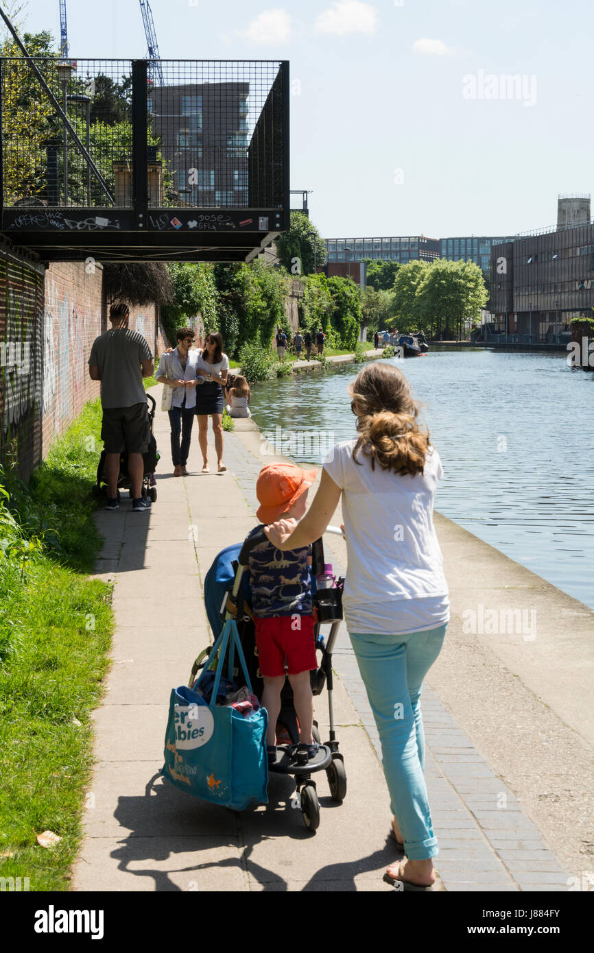 A woman pushing a pushchair next to the Grand Union Cana, King's Cross ...