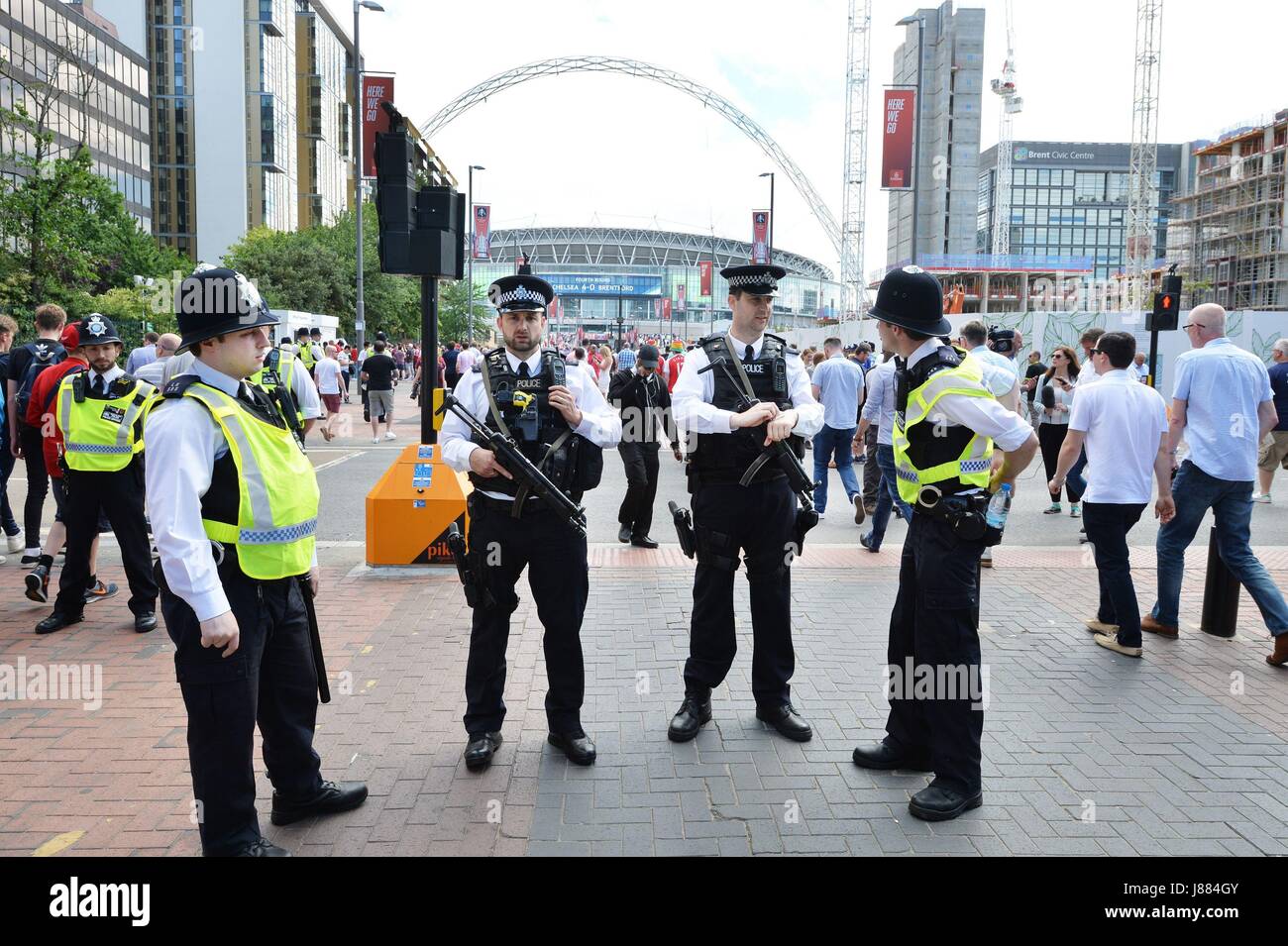 Armed police officers patrol outside Wembley Stadium during the FA Cup ...