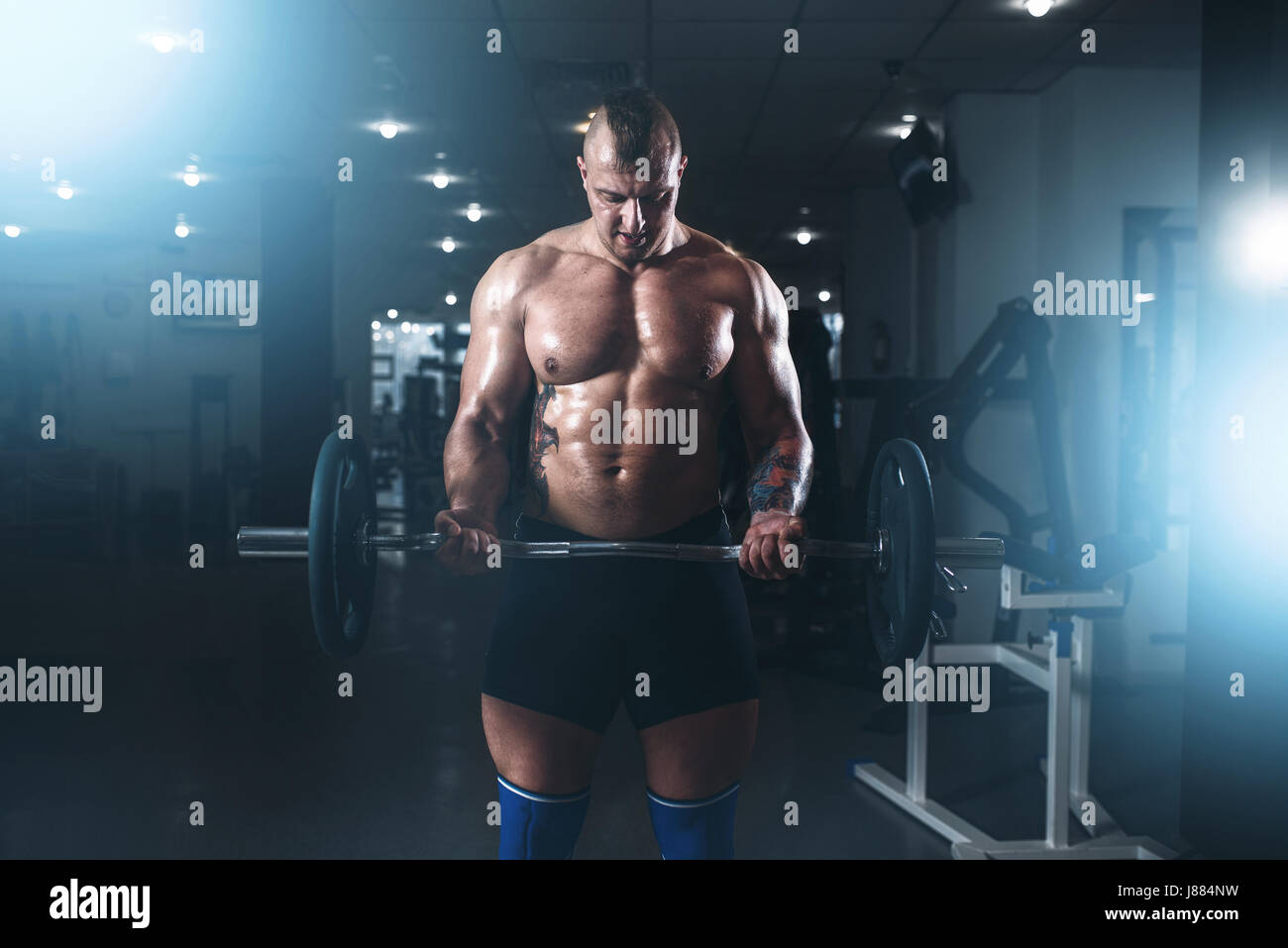 Strong athlete exercise with weight in fit gym. Fitness training with ...