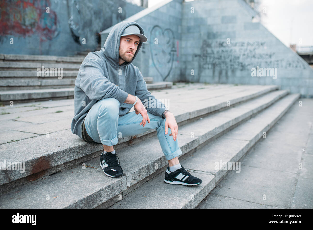 Dance performer sitting on the steps, urban dancing style, street ...