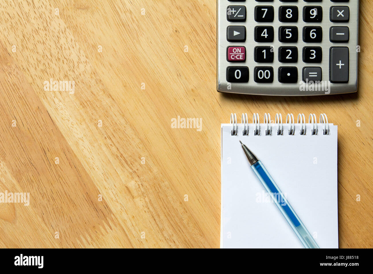 Calculator, pen, blank note book on wood table Stock Photo - Alamy
