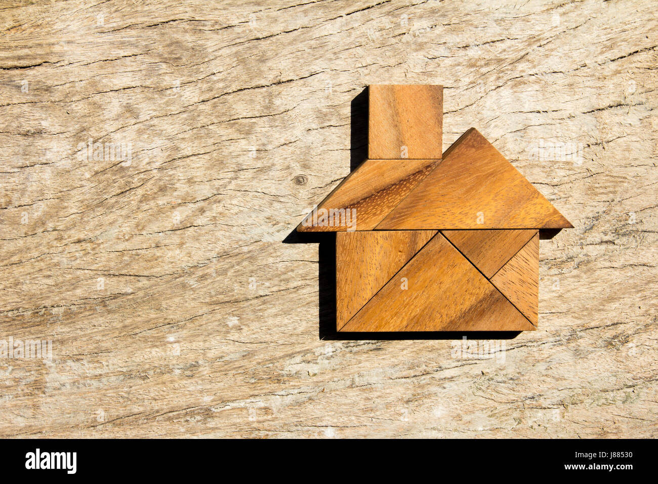 Wooden tangram puzzle in home shape for dream home or happy life ...