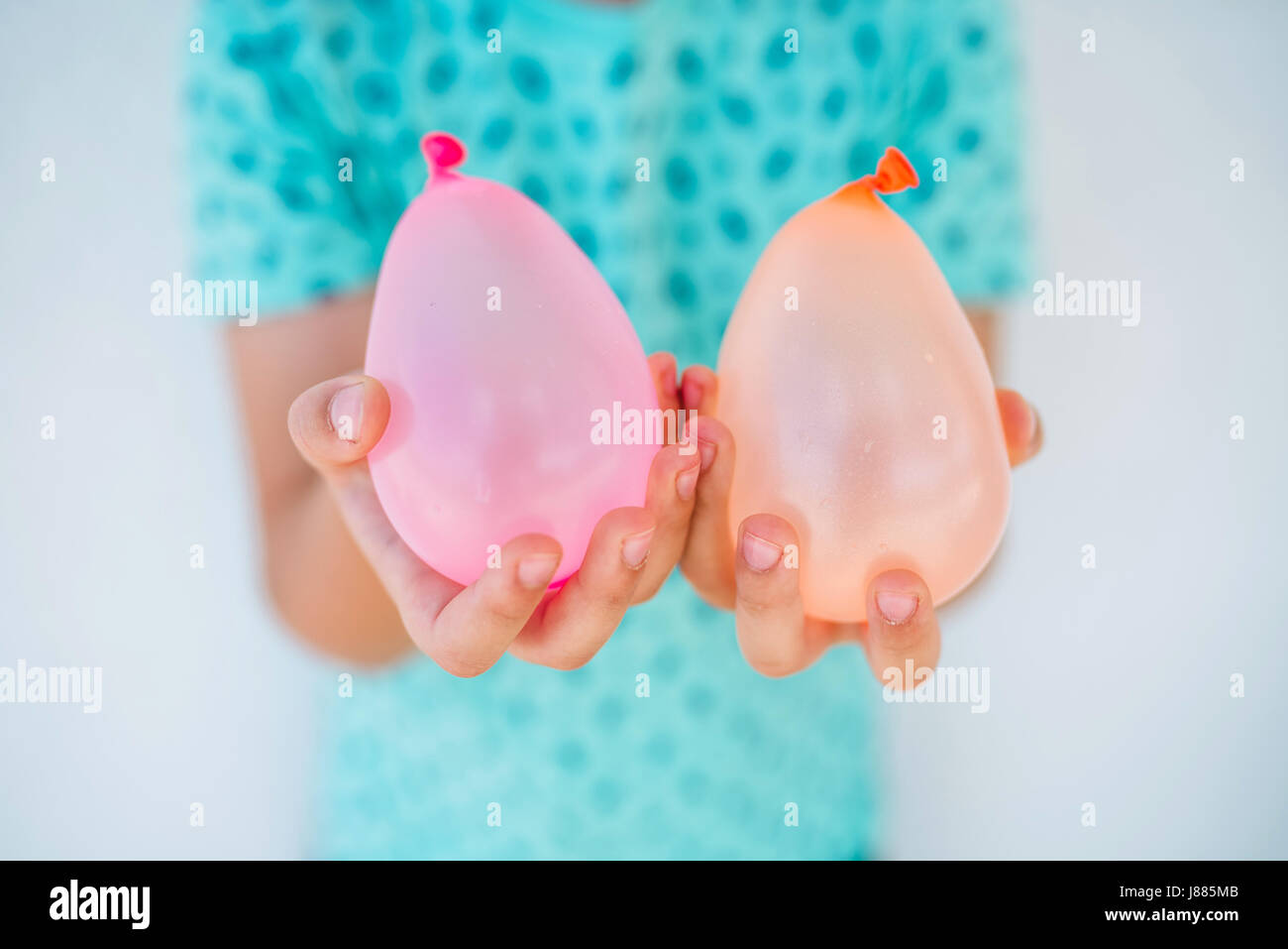 Boy is holding water balloons Stock Photo - Alamy