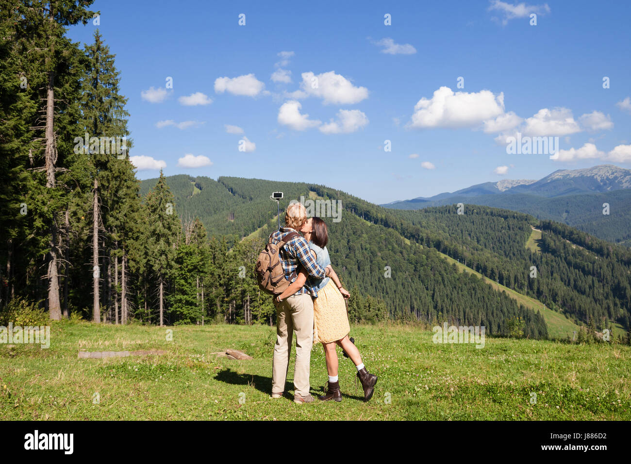 Beautiful travelling couple in love making selfie over mountain ...