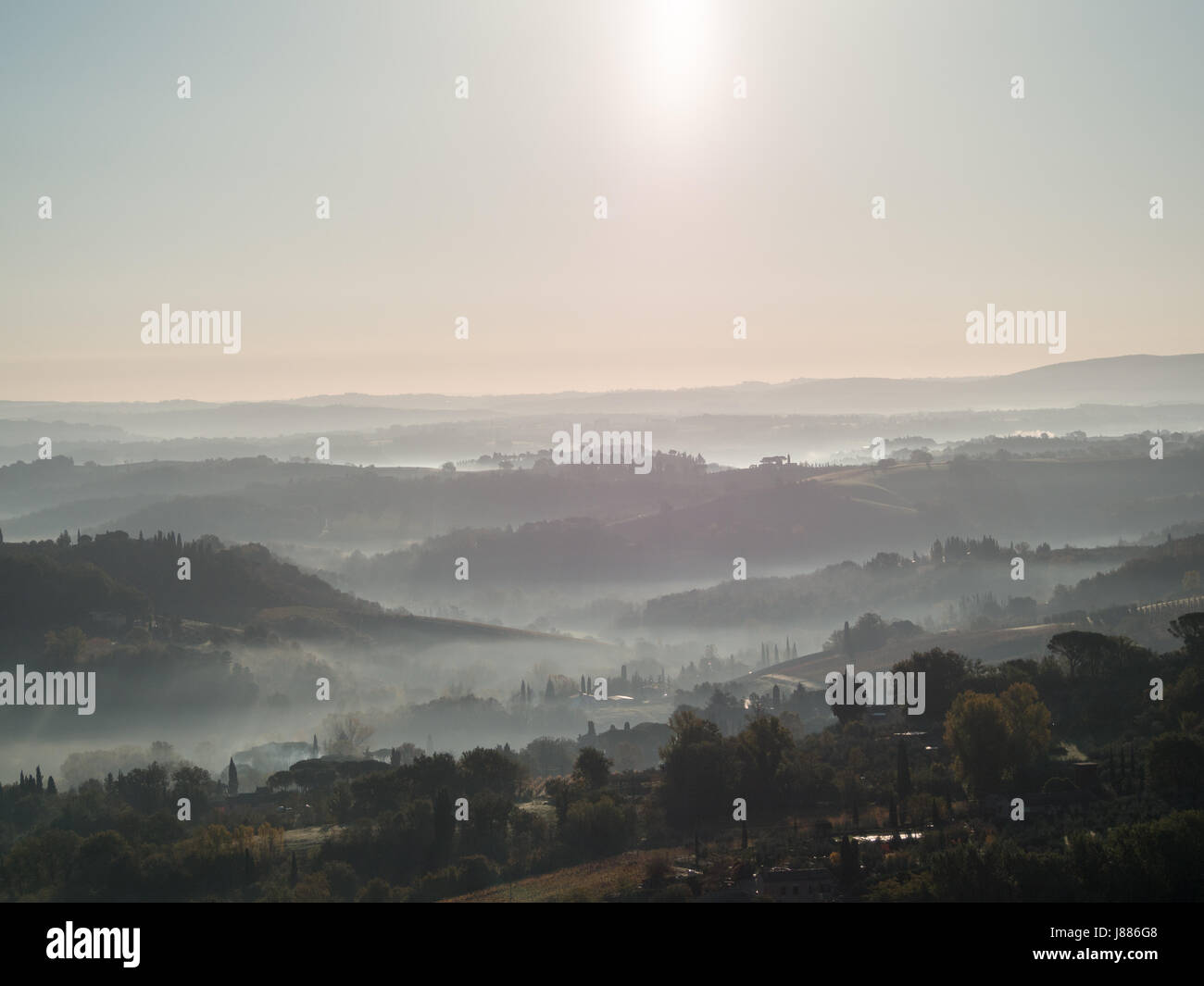 Tuscany landscape with dawn mist Stock Photo - Alamy