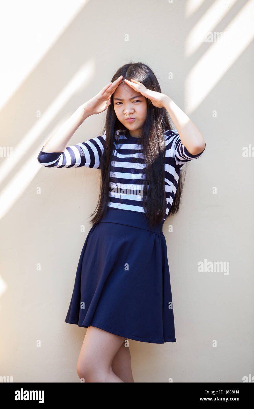 portrait of asian teen age smiling face standing at home with relax and ...