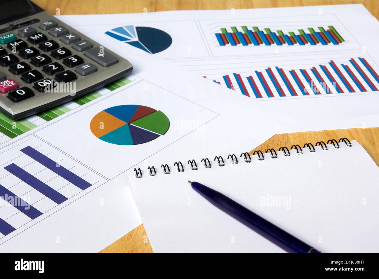 Blank note book with financial graph, calculator and pen background ...