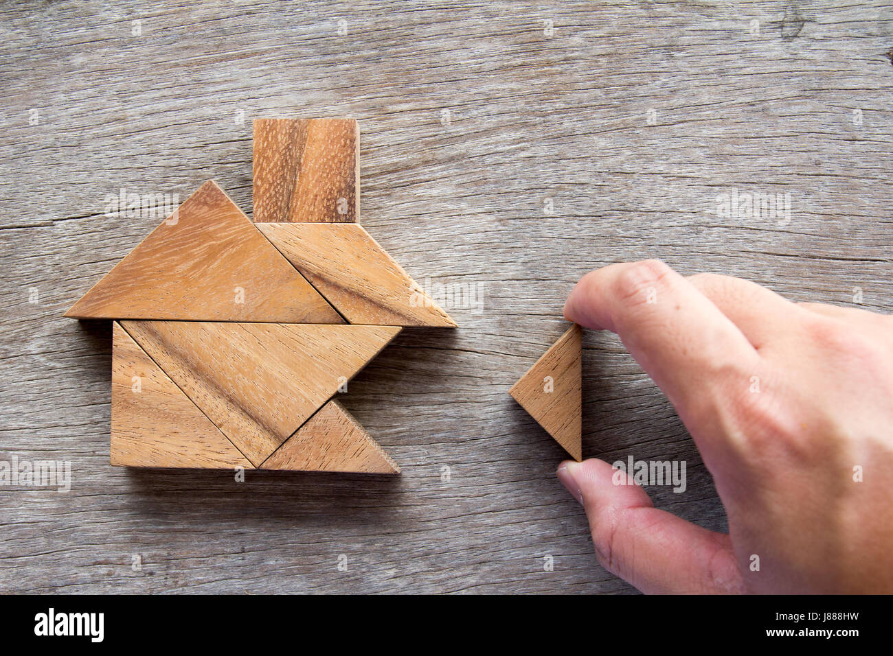 Wooden tangram puzzle wait to fulfill home shape for build dream home ...