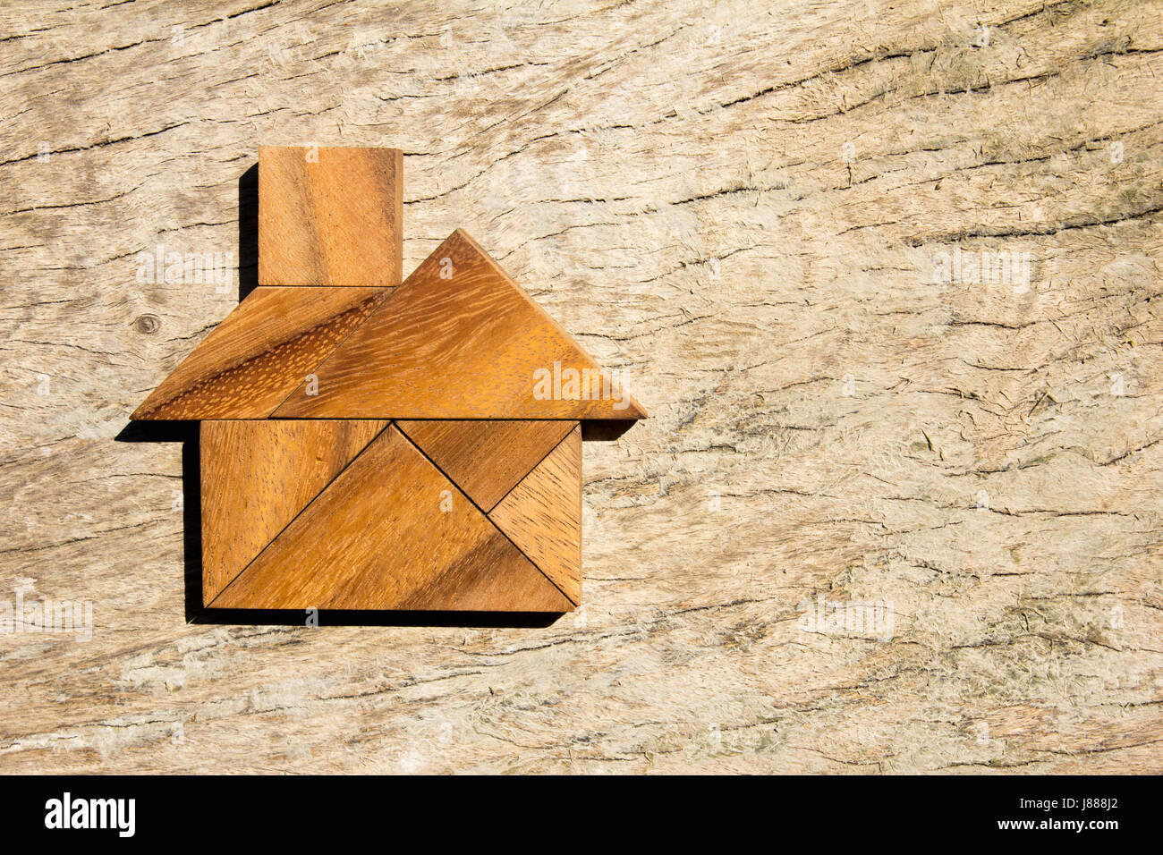 Wooden tangram puzzle in home shape for dream home or happy life ...