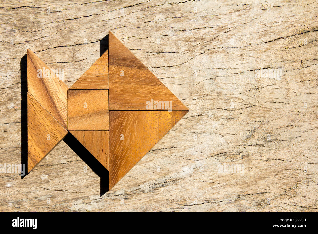 Wooden tangram puzzle in fish shape with copy space background Stock ...