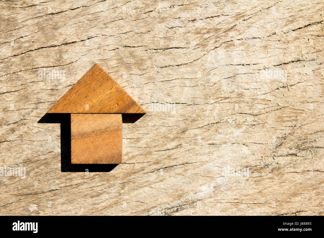 Wooden tangram puzzle in home shape for dream home or happy life ...