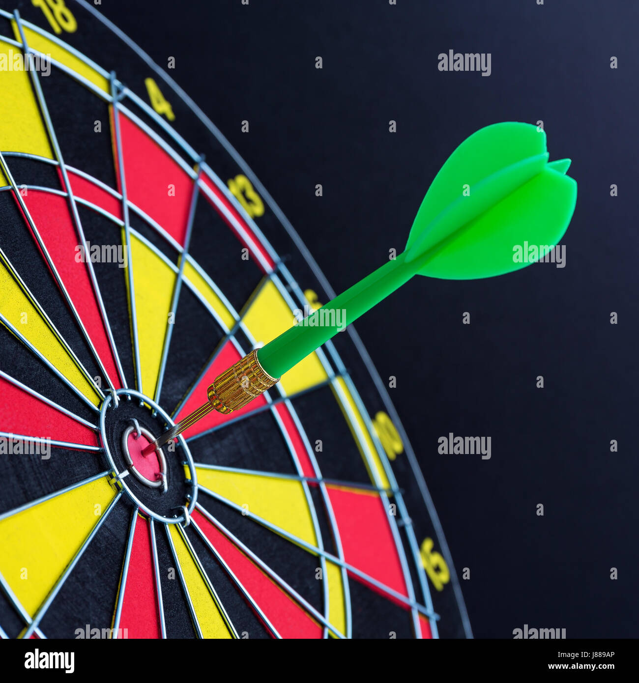 Dart arrow hitting in the target center of dartboard Stock Photo - Alamy