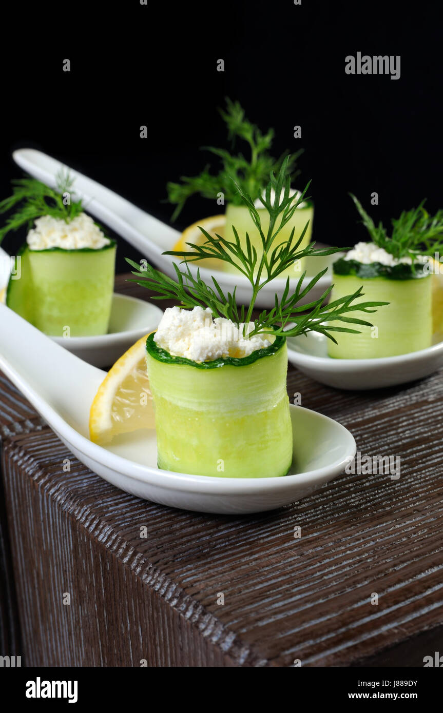 Cucumber canape with ricotta and lemon slice close-up Stock Photo - Alamy