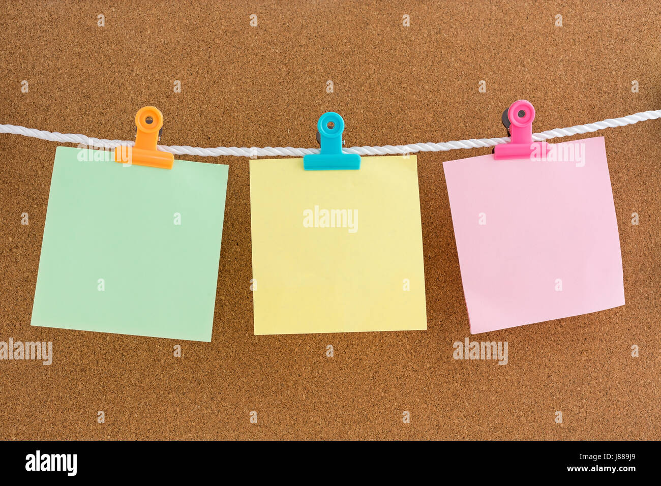 Blank notes with Letter Clips on cork bulletin board Stock Photo - Alamy