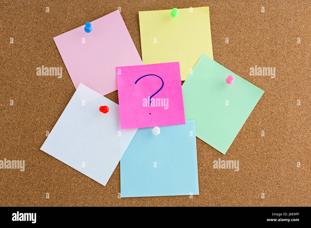 Notes with question marks on cork bulletin board Stock Photo - Alamy