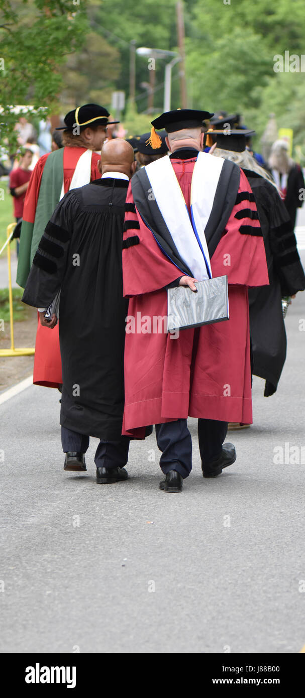 Two professors in conversation as they walk to commencement ceremonies ...