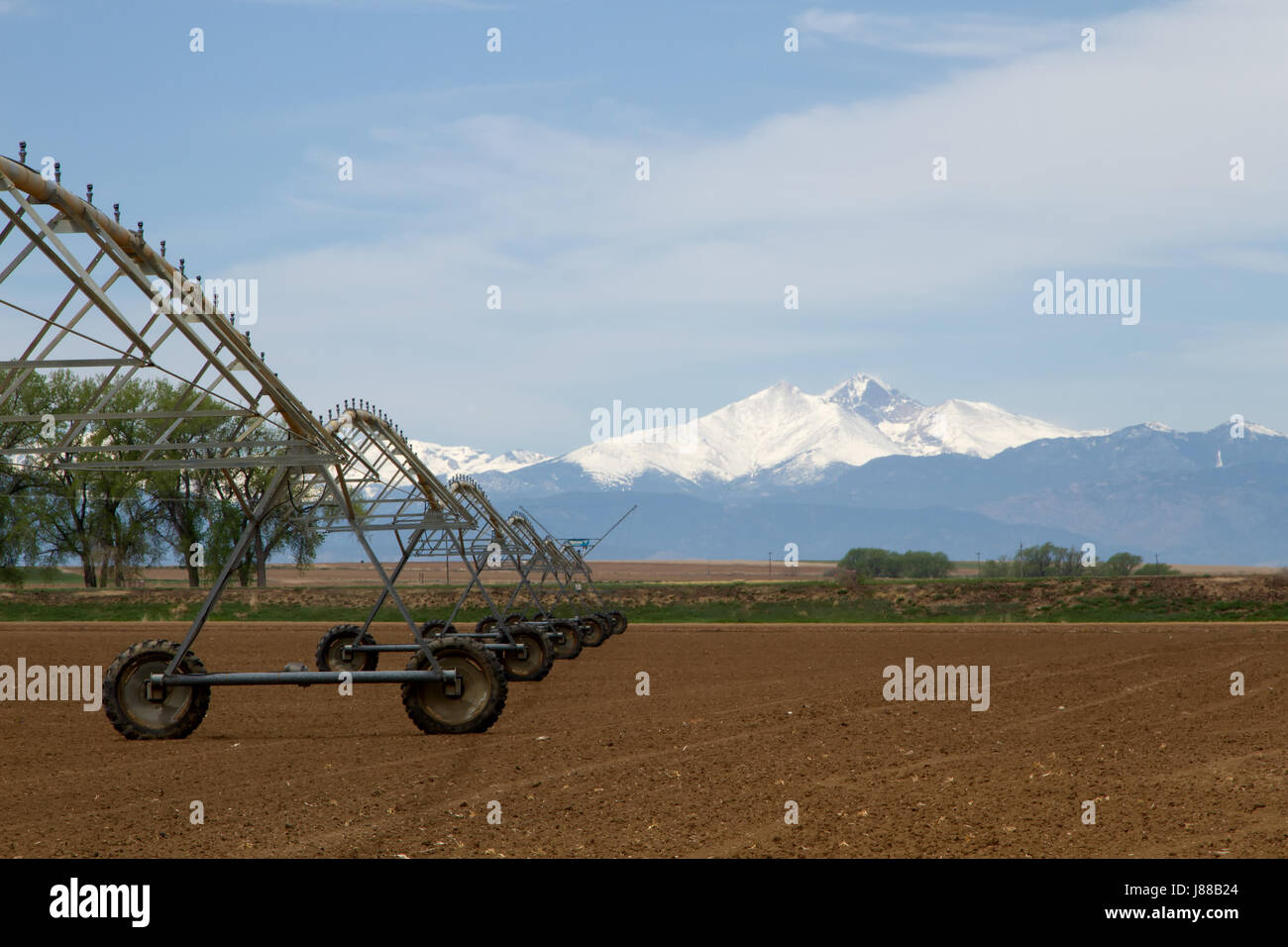 A Pivot Irrigation System in a farming field with Longs Peak Mountain ...