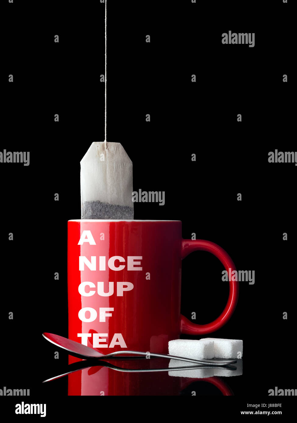 Red mug of tea. With spoon and sugar Stock Photo - Alamy