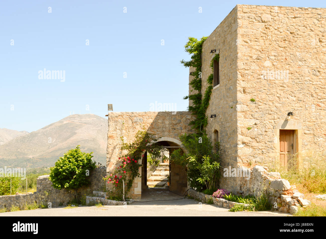 Entrance portico of an ancient abbey with the mountain in background on ...
