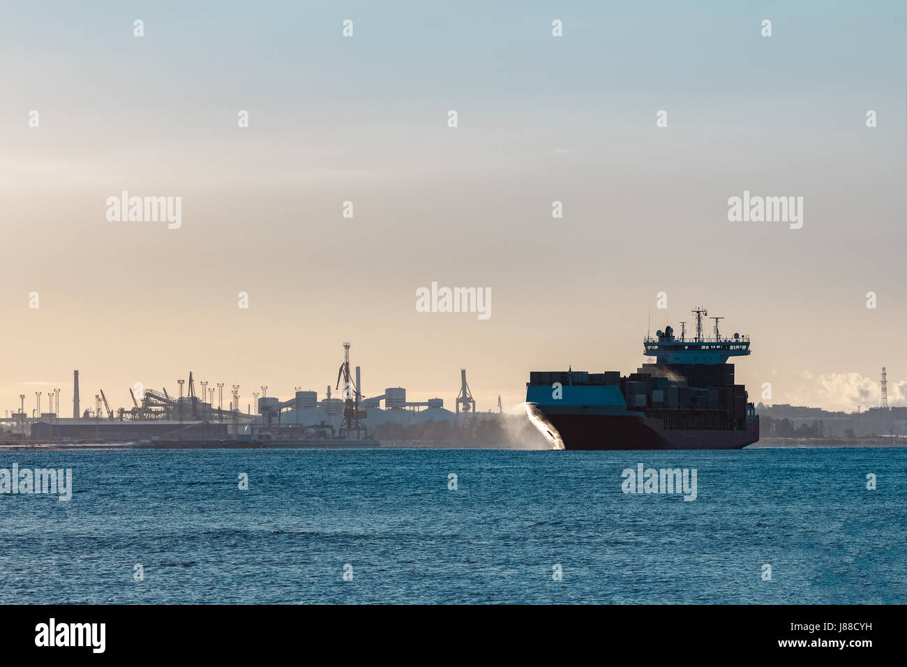Full red container ship moving in still water Stock Photo - Alamy
