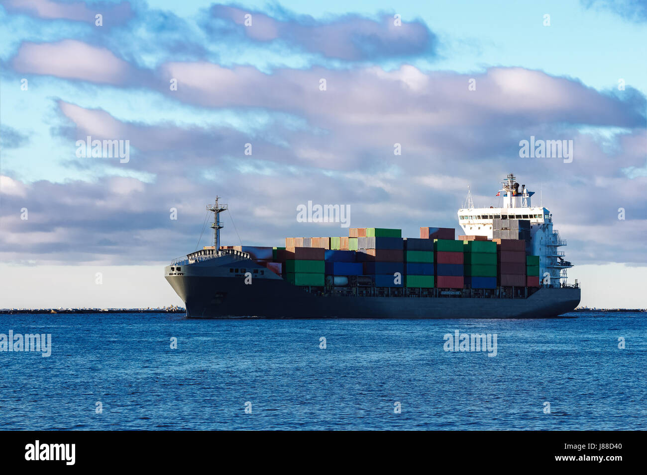 Modern grey container ship moving in still water Stock Photo - Alamy