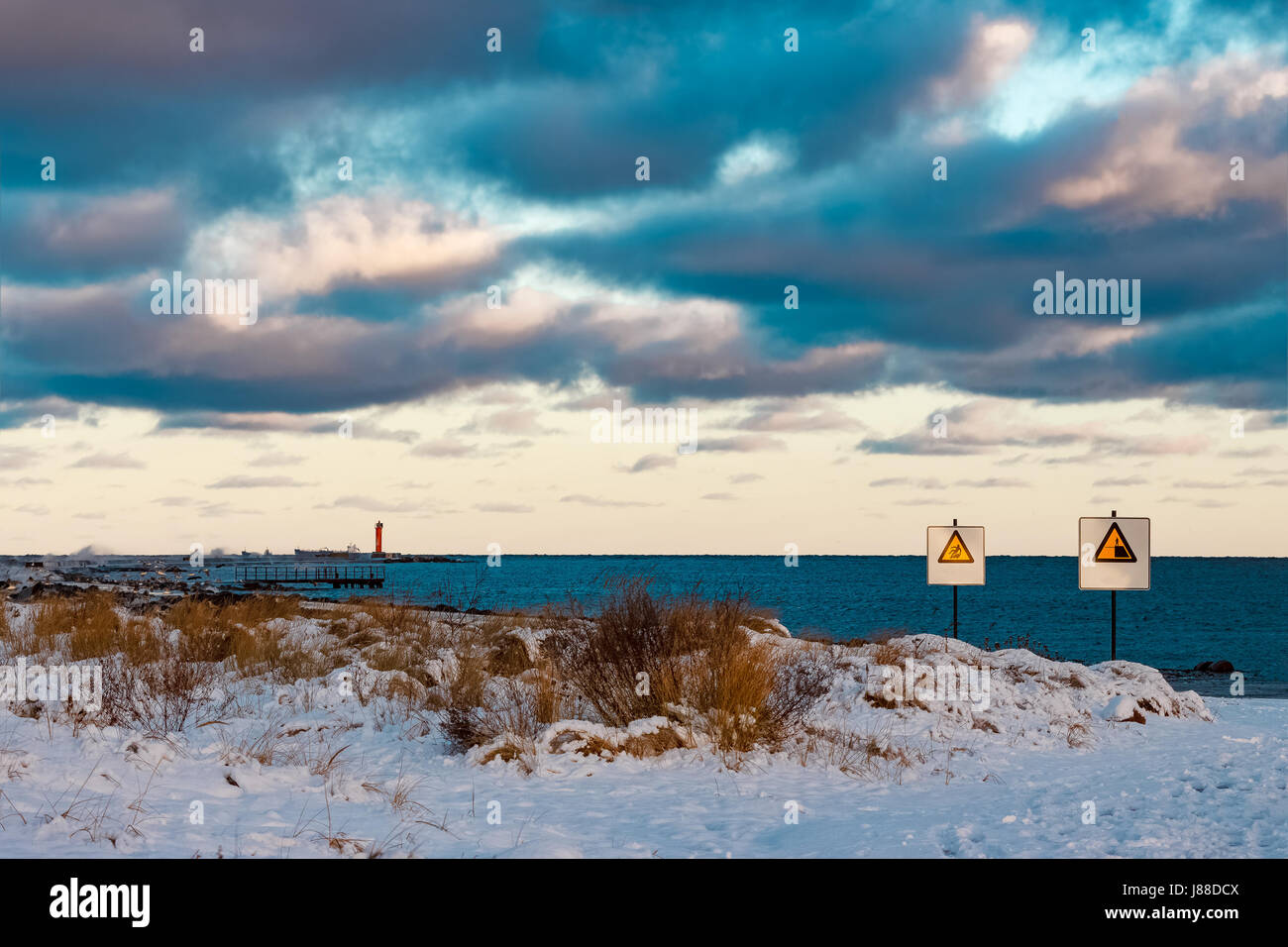 Two yellow warning signs on the winter beach Stock Photo - Alamy