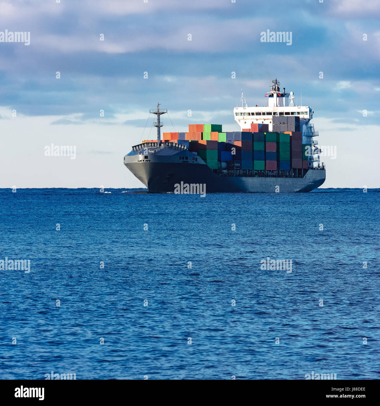Modern grey container ship moving in still water Stock Photo - Alamy