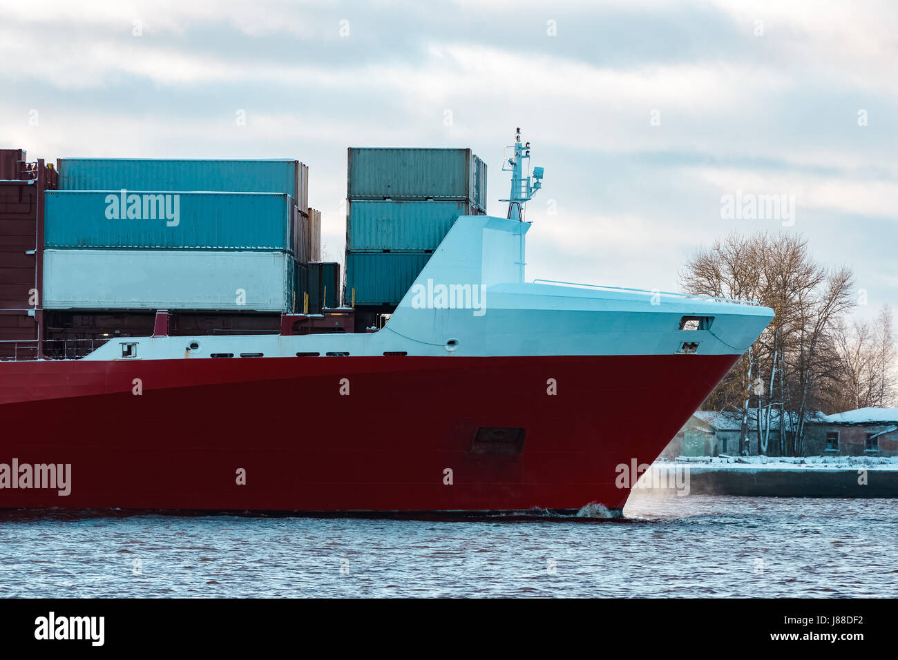 Full red container ship moving in still water Stock Photo - Alamy