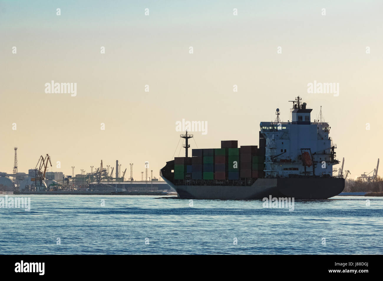 Modern grey container ship moving in still water Stock Photo - Alamy