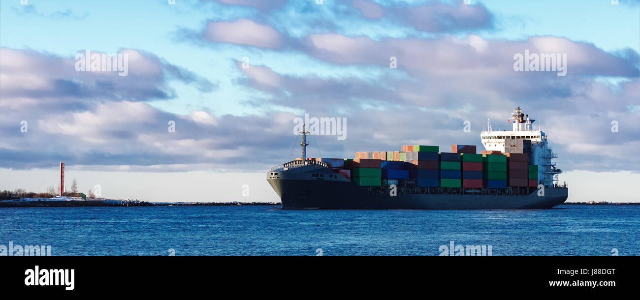Modern grey container ship moving in still water Stock Photo - Alamy