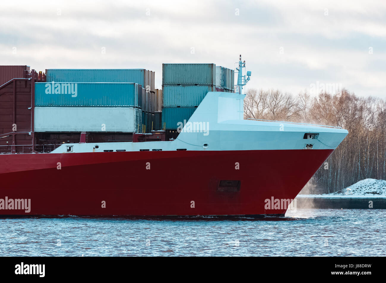 Full red container ship moving in still water Stock Photo - Alamy
