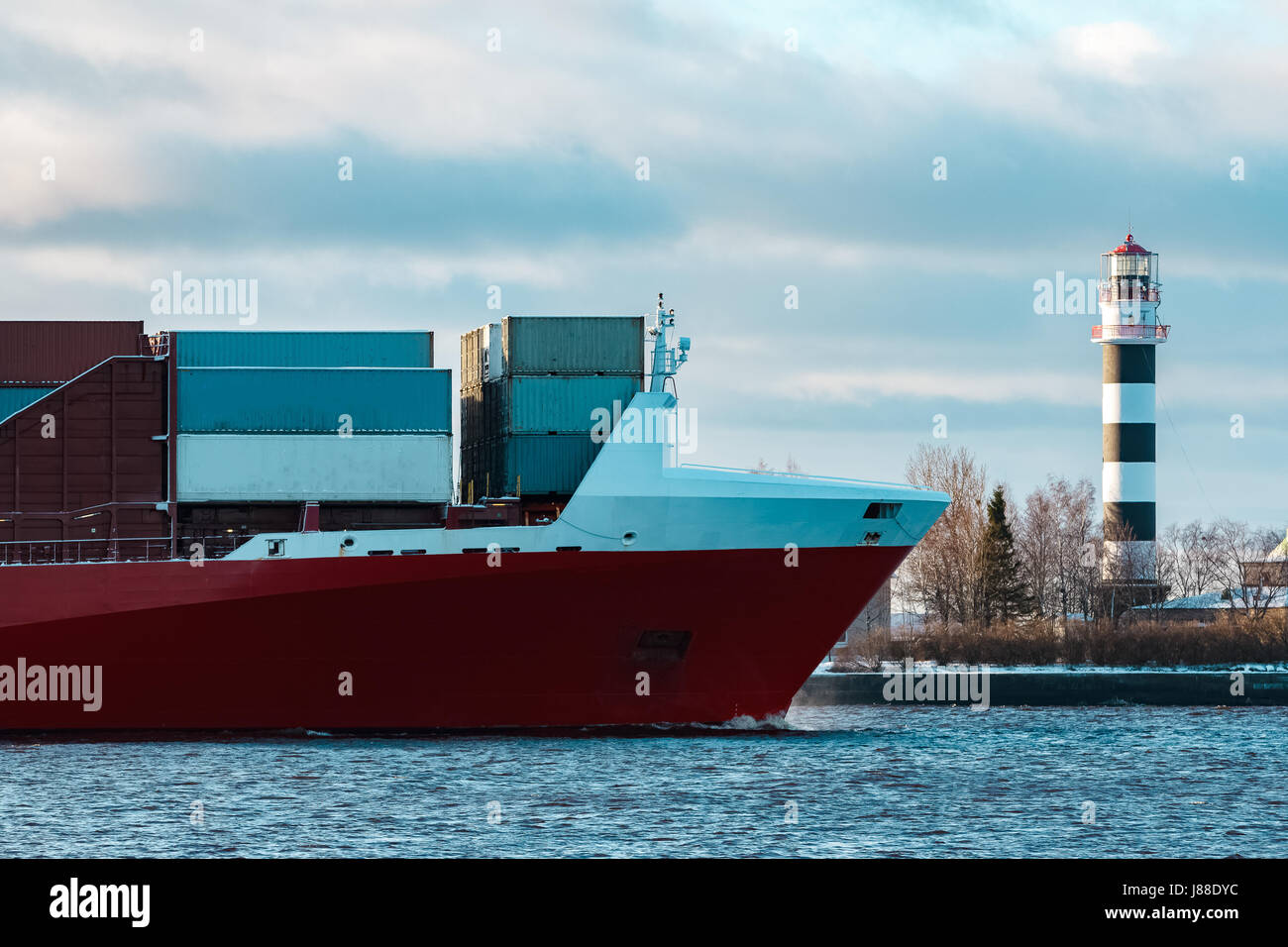 Full red container ship moving in still water Stock Photo - Alamy