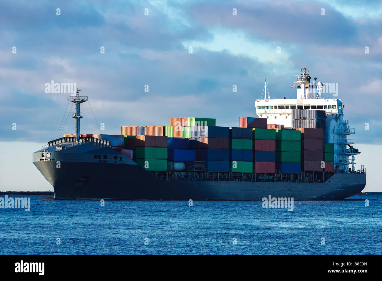 Modern grey container ship moving in still water Stock Photo - Alamy