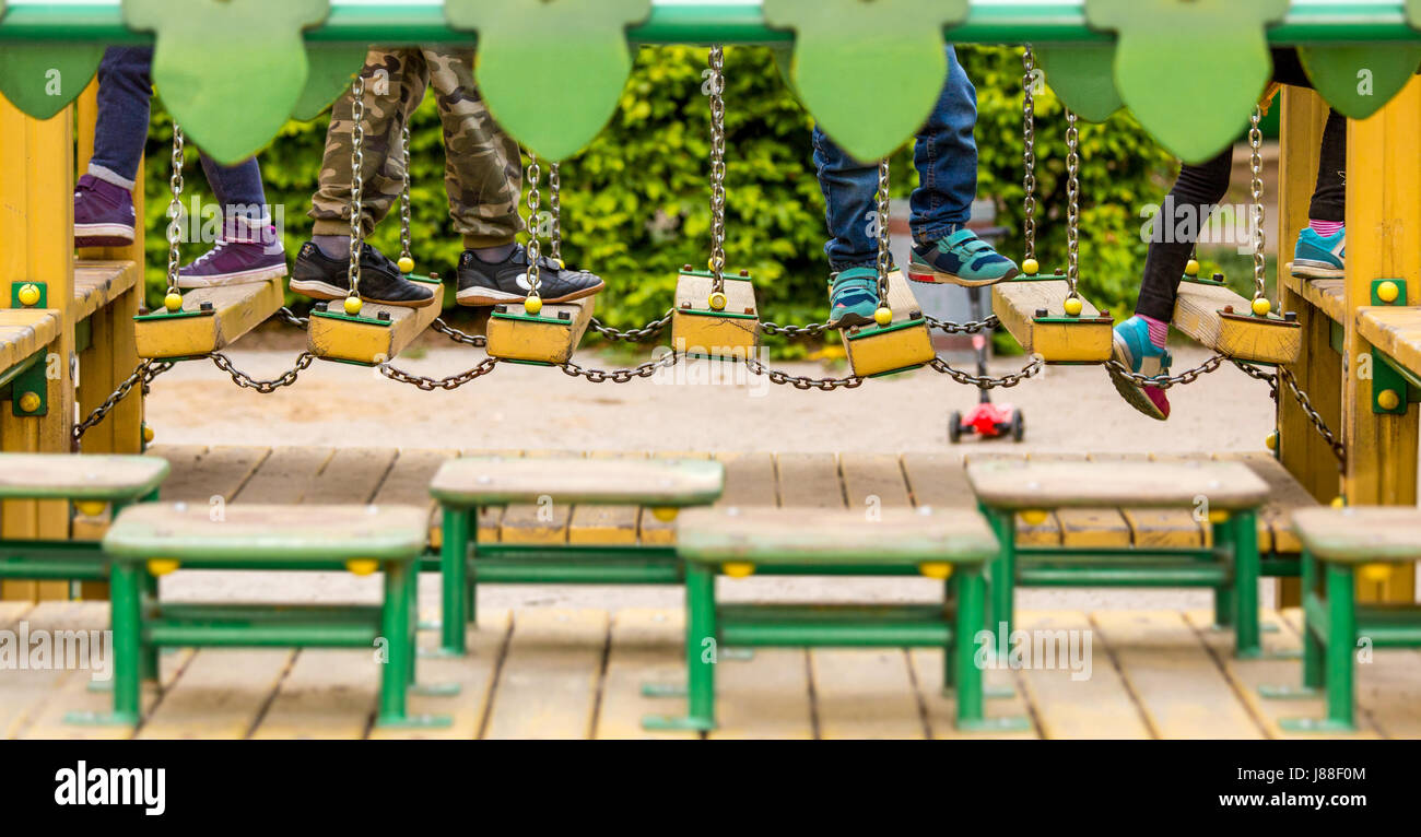 Children's feet on a swing path at a playground Stock Photo - Alamy