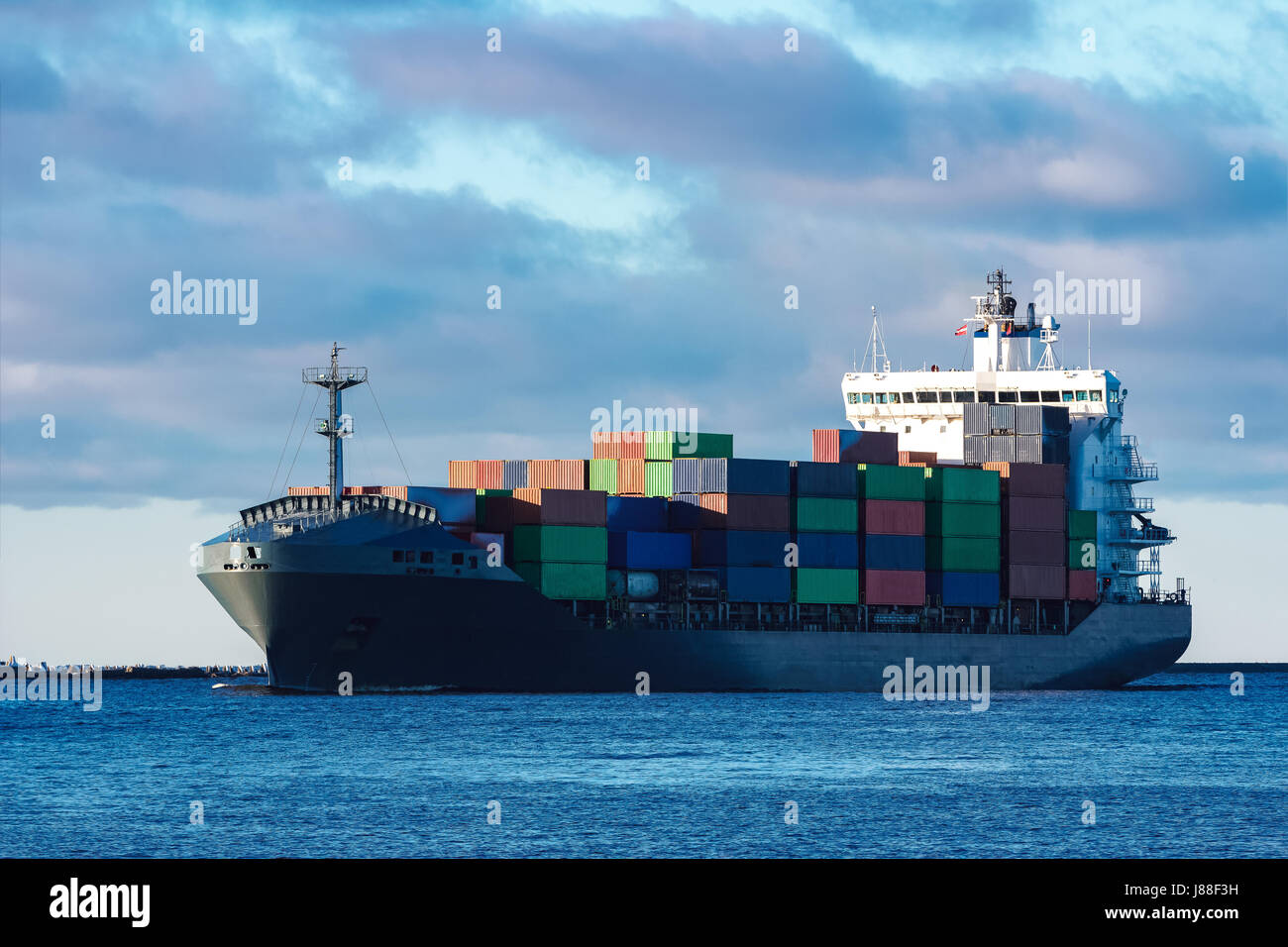 Modern grey container ship moving in still water Stock Photo - Alamy