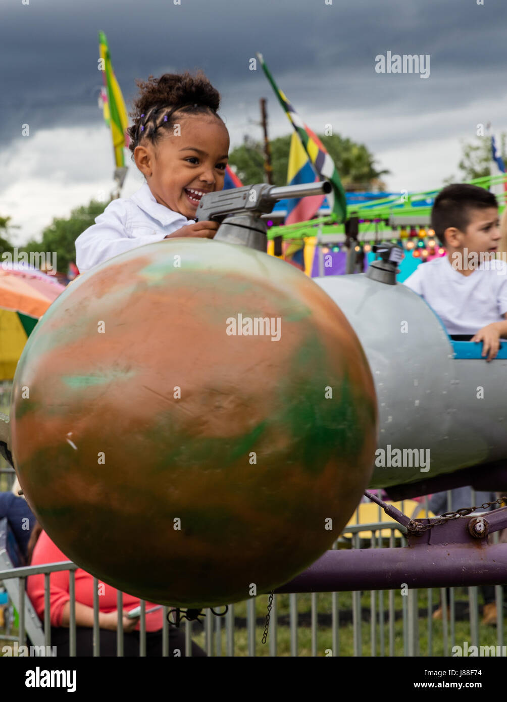 Children having fun on a ride at the county fair Stock Photo - Alamy