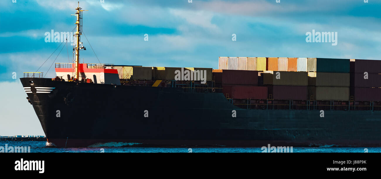 Modern black container ship moving from Baltic sea Stock Photo - Alamy