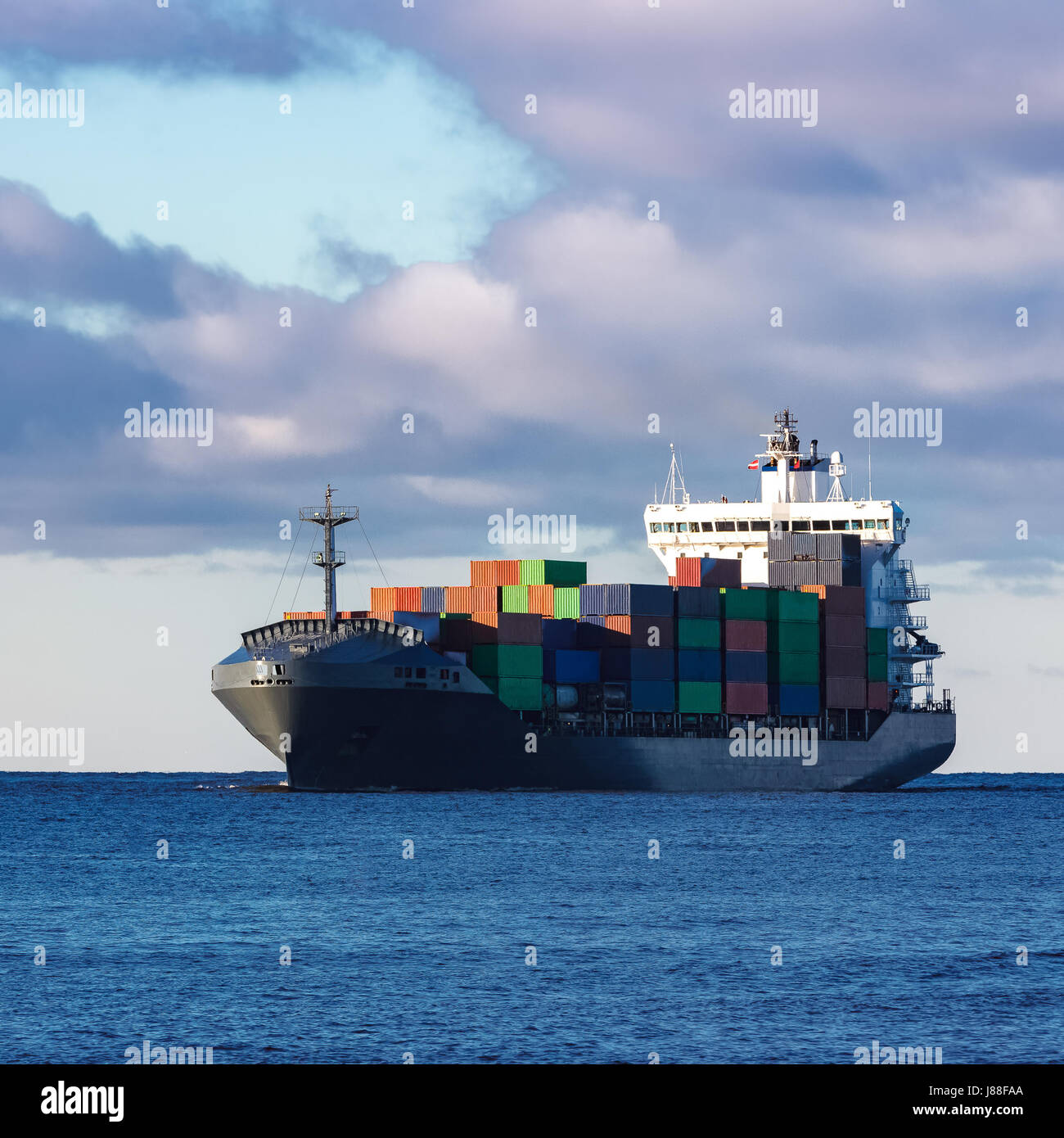 Modern grey container ship moving in still water Stock Photo - Alamy