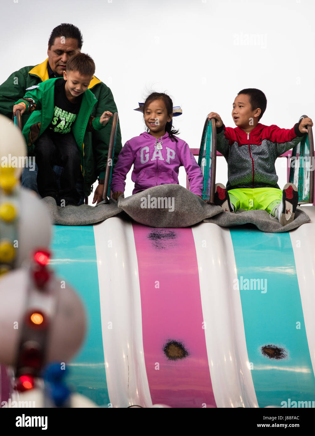 Children playing on a giant slide at the county fair Stock Photo - Alamy