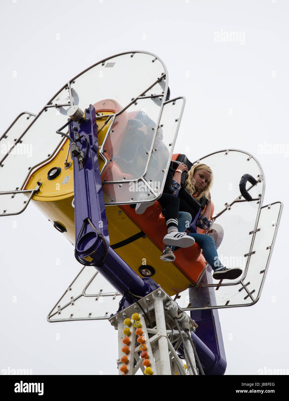 Children having fun on a ride at the county fair Stock Photo - Alamy