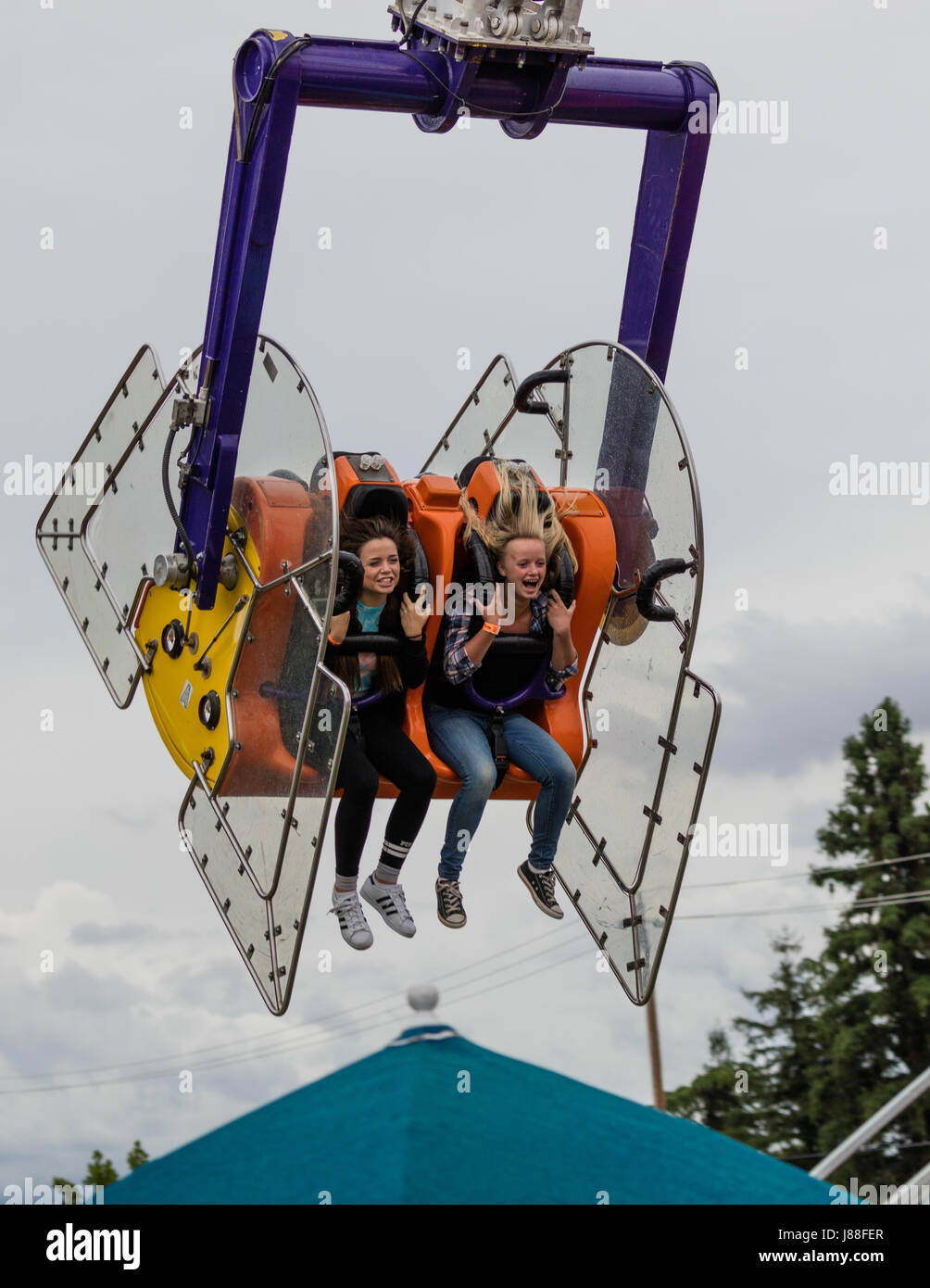 Children having fun on a ride at the county fair Stock Photo - Alamy