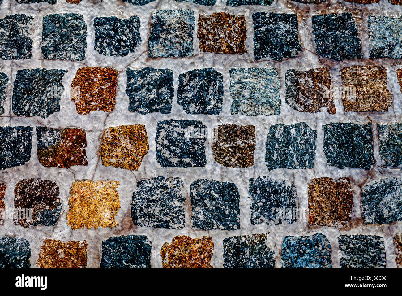 Running water over square stone paving Stock Photo - Alamy