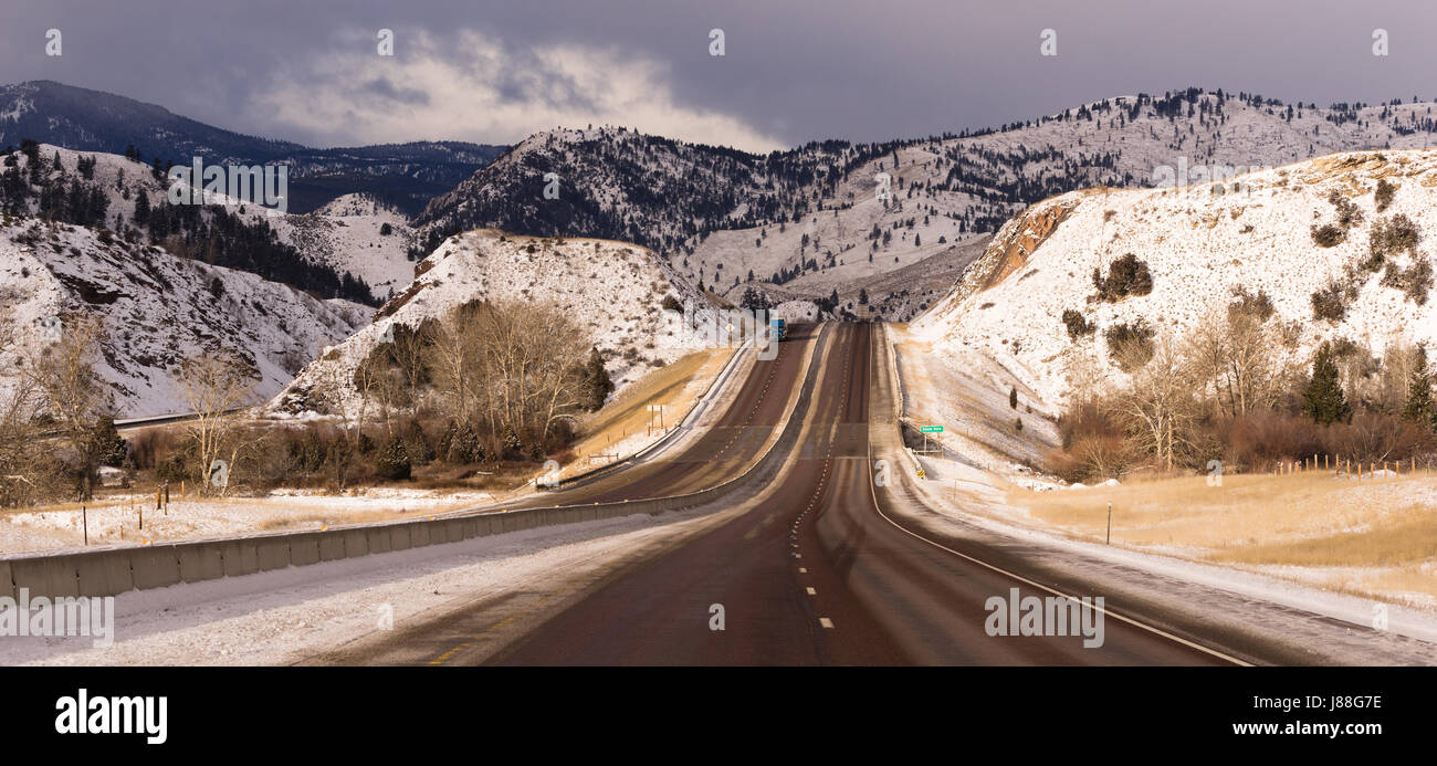 Winter scene with tucks coming and going on icy roads in Utah Stock ...
