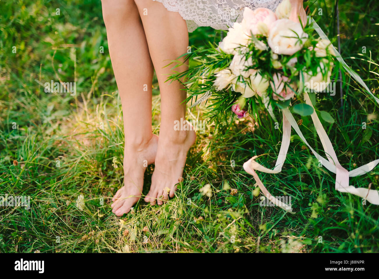 Legs of the bride and bouquet. Wedding in Montenegro Stock Photo - Alamy