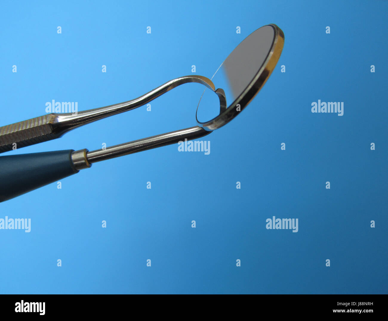 scaler and dental mirror Stock Photo - Alamy